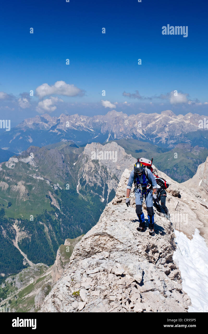 Hikers climbing Mt Marmolata, fixed rope route on west ridge, Dolomites ...
