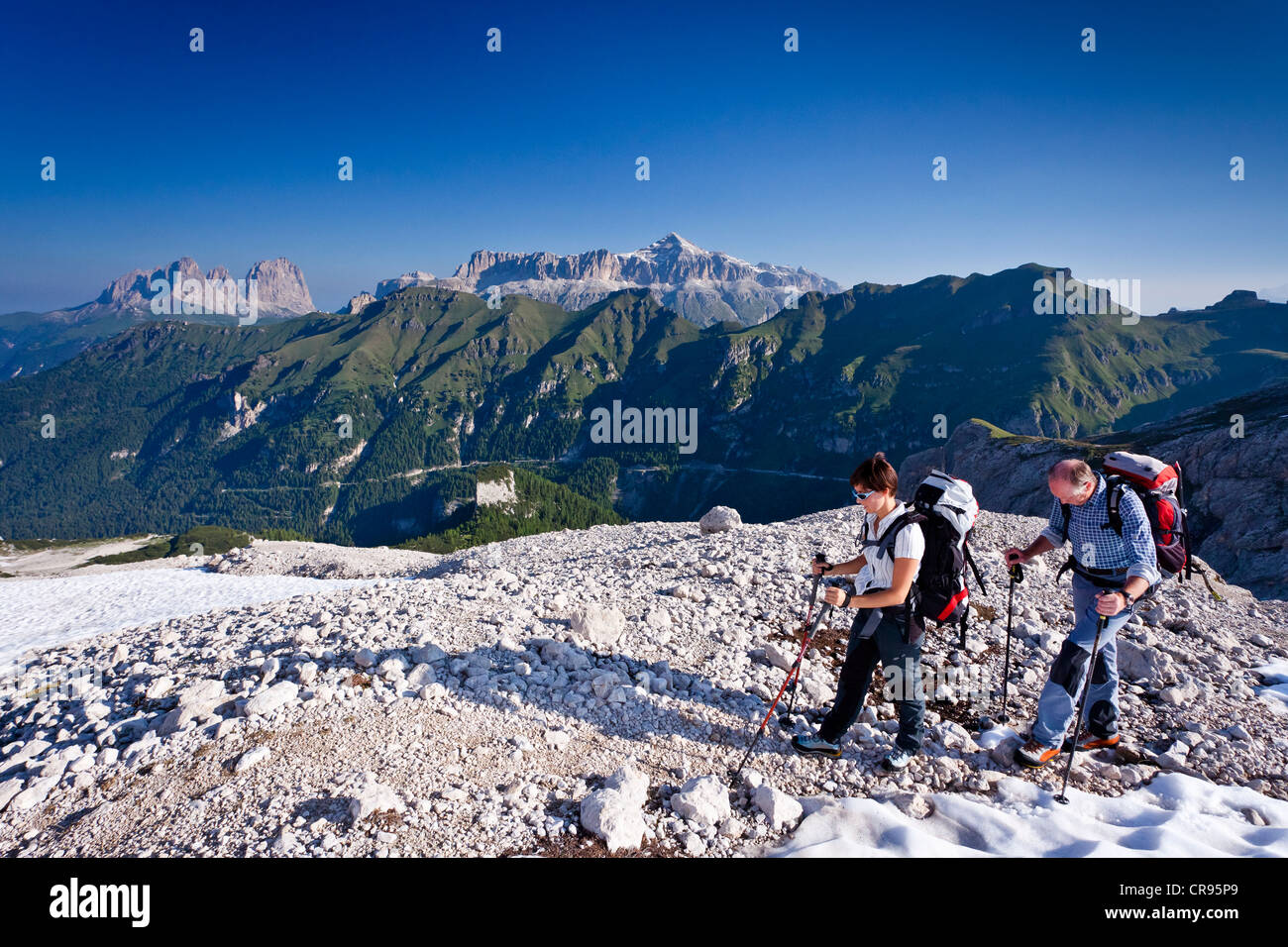 Hikers climbing Mt Marmolata, fixed rope route on west ridge, Mt Sella ...