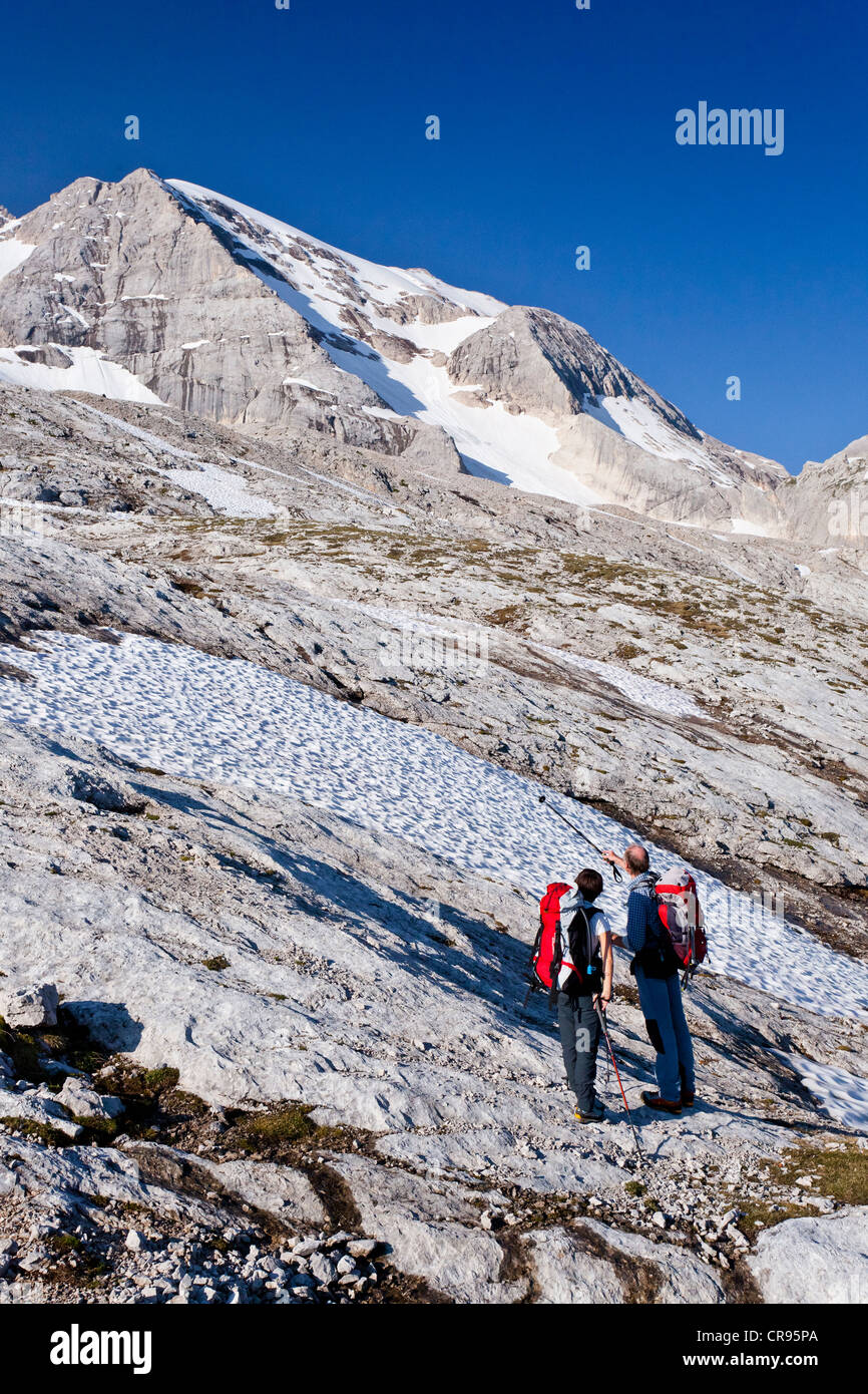 Hikers climbing Mt Marmolata, fixed rope route on west ridge, Mt ...