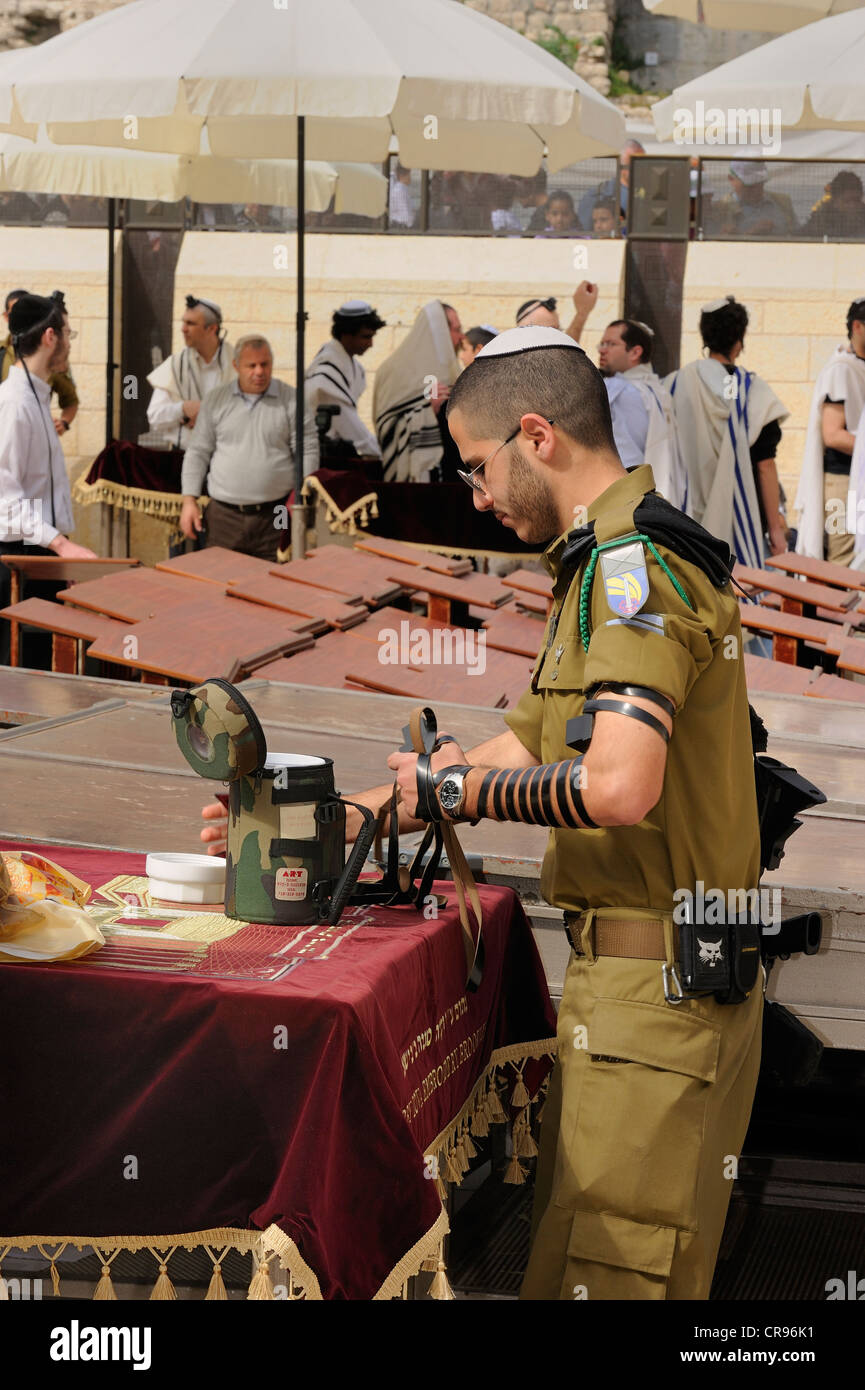 Israeli soldier getting prepared for his prayer in front of the Wailing ...