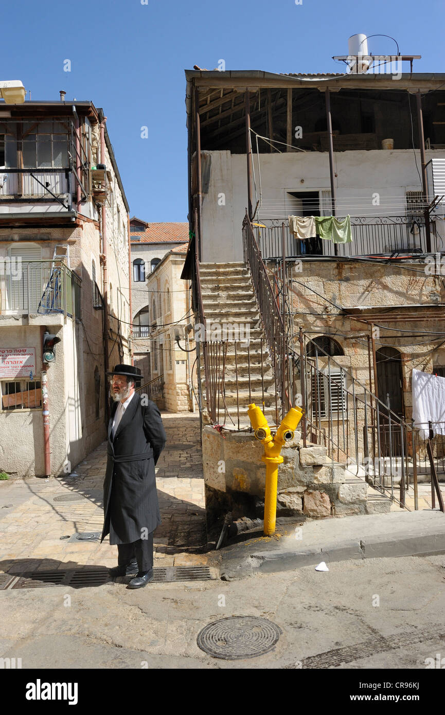 Orthodox Jew with typical houses in the district of Me'a She'arim or ...