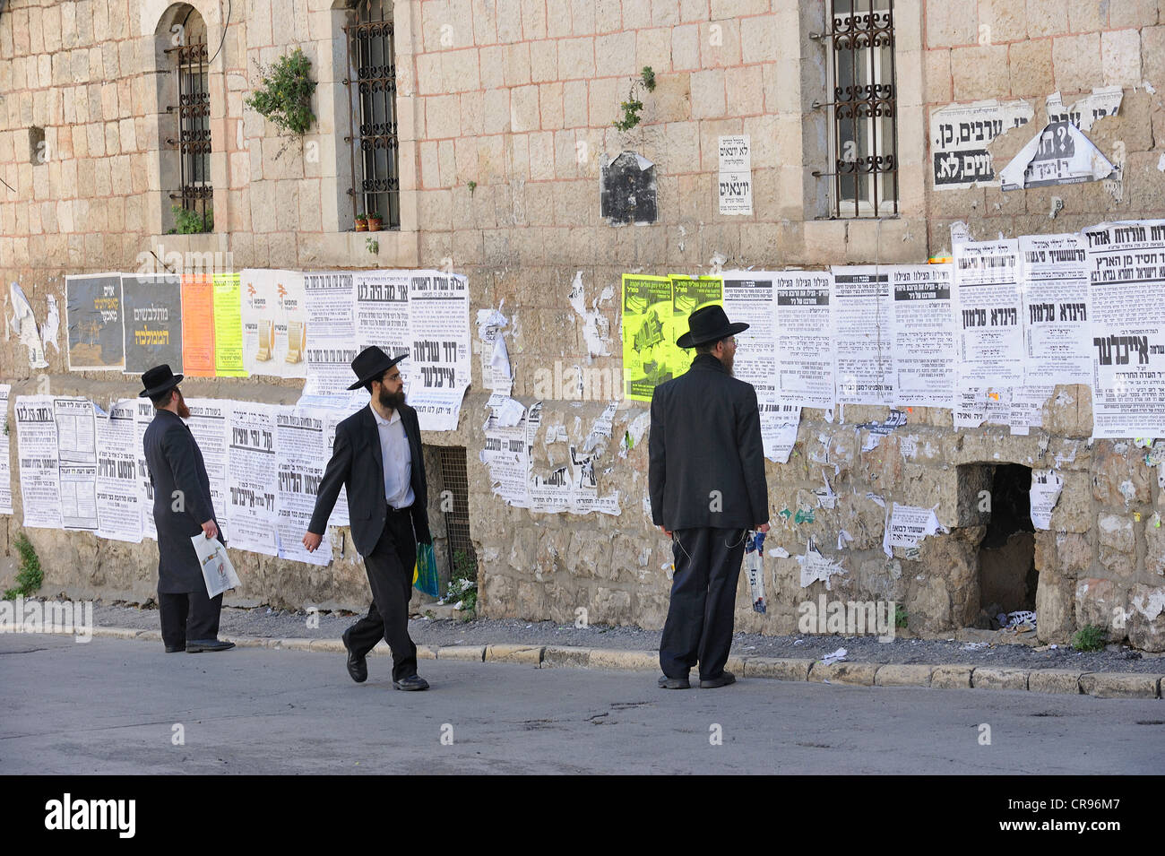 Orthodox Jews reading wall newspapers in the district of Me'a She'arim ...
