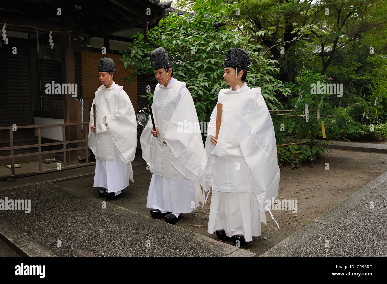 Shinto priests carrying scepters and wearing hats, Nashinoki Shrine ...