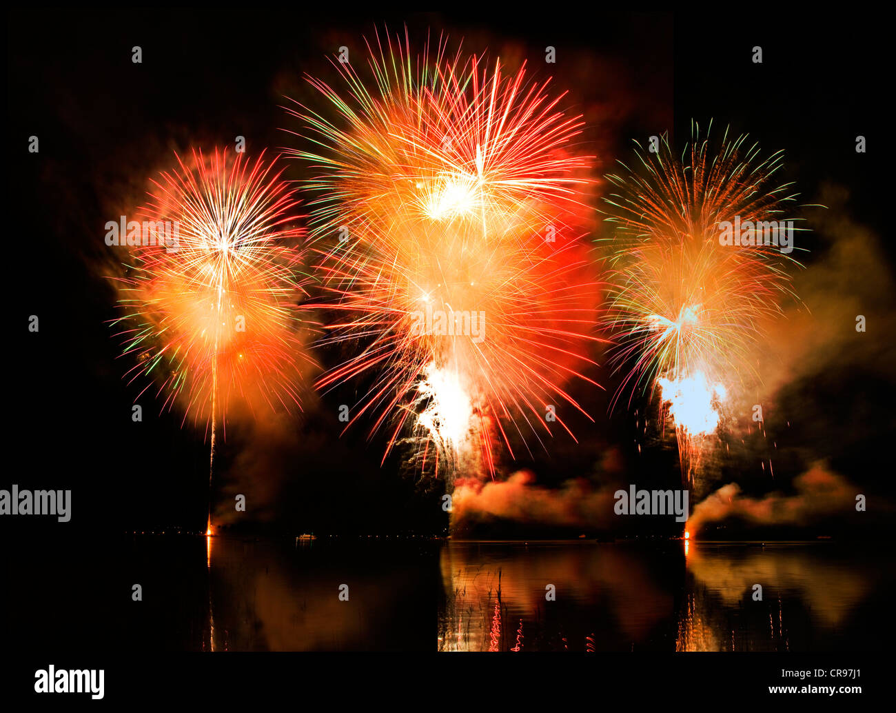 Aerial fireworks display on the lake, triple mushroom clouds with ...