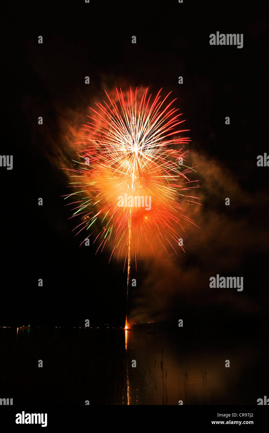 Aerial fireworks display on the lake, mushroom cloud with reflections ...