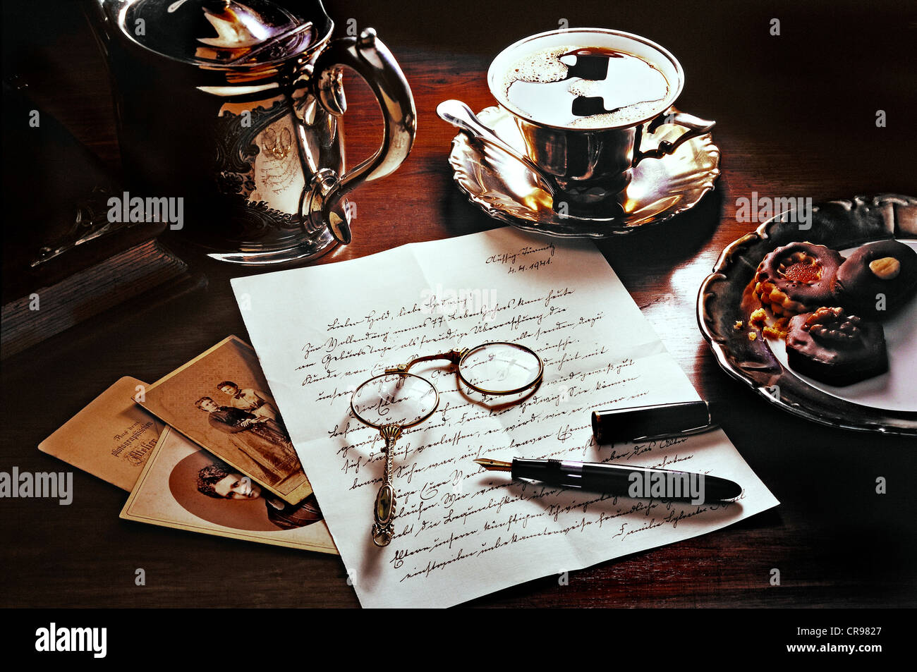 Old letter with coffee, cookies, fountain pen, photos and a lorgnette ...