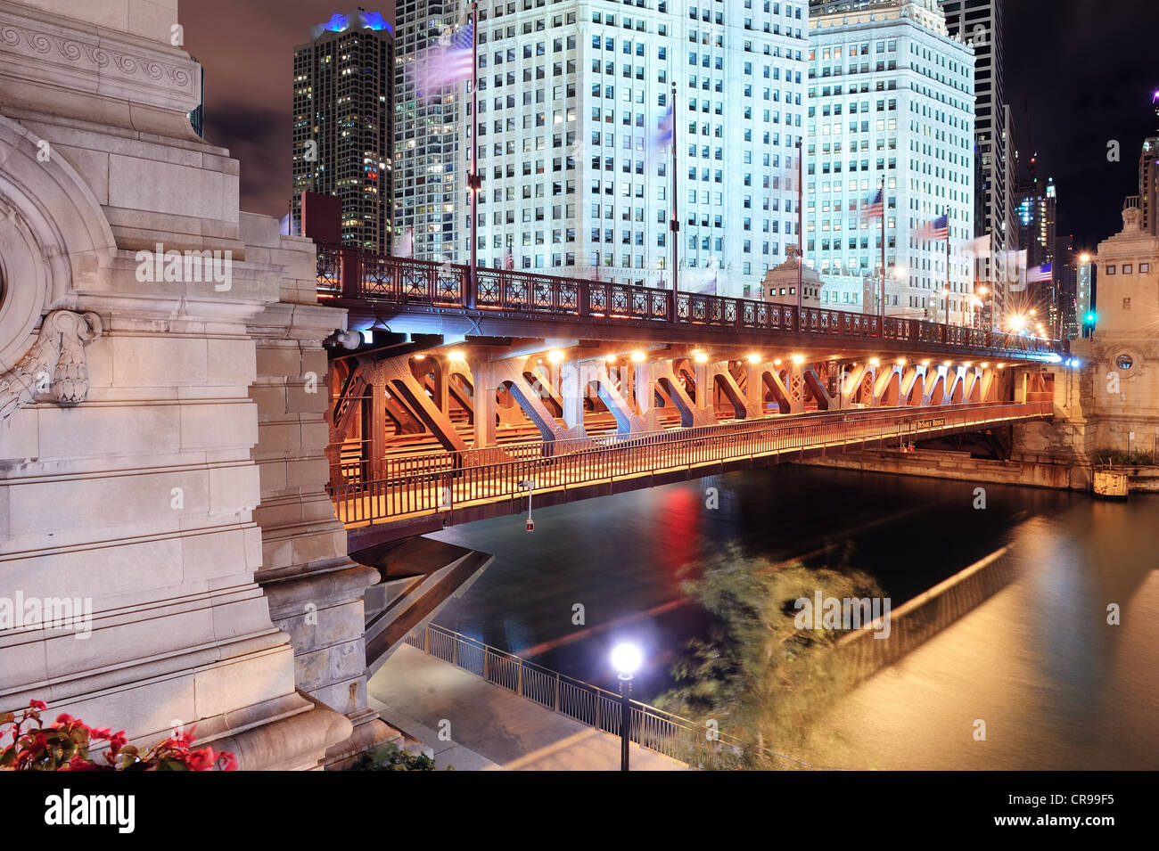 Chicago River Walk with urban skyscrapers and bridge illuminated with ...