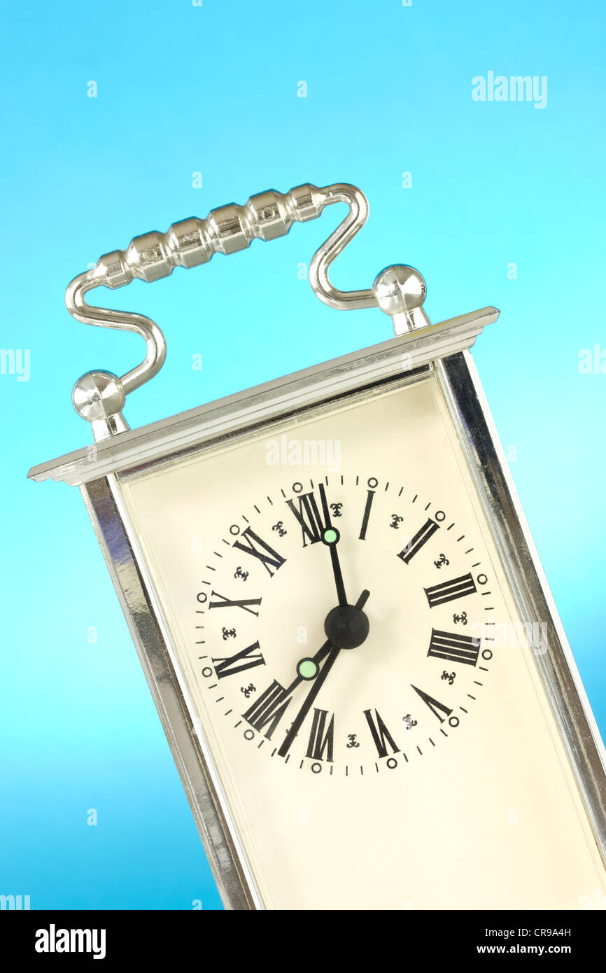 old analogue clock over a blue background Stock Photo - Alamy