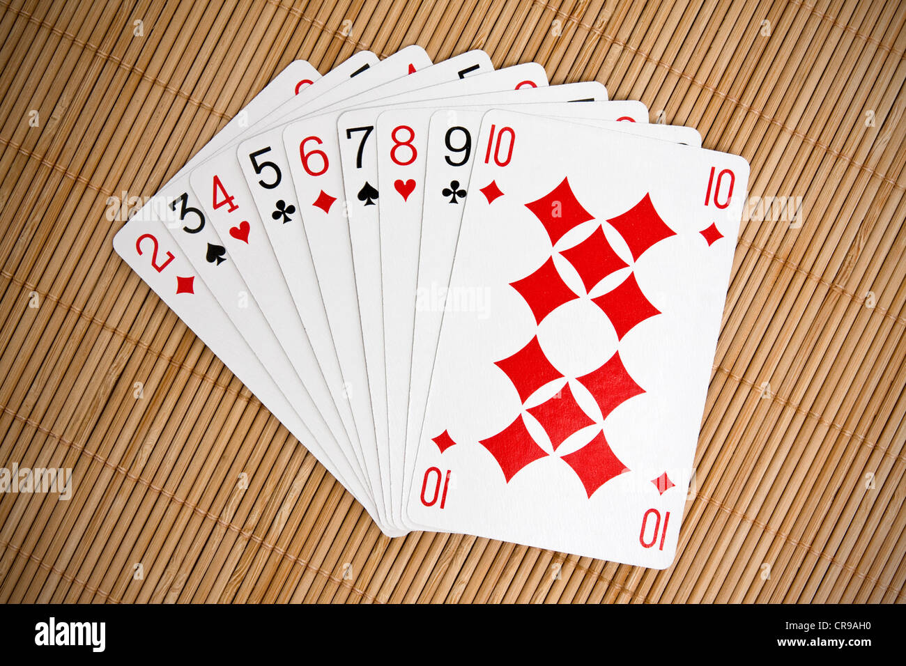 set of playing cards on bamboo background Stock Photo - Alamy