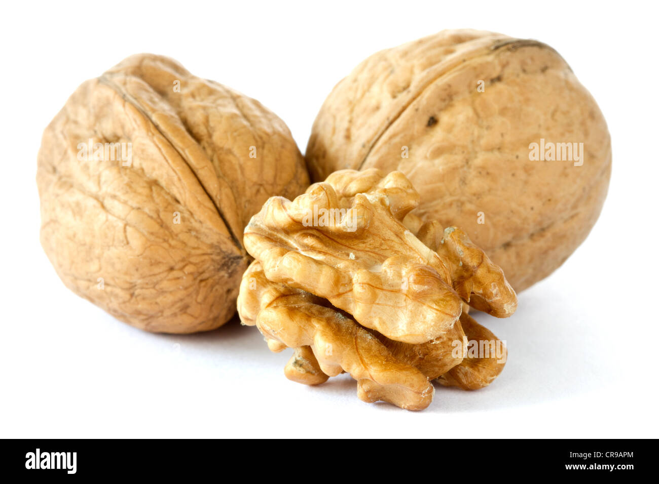 three dried walnuts on a white background Stock Photo - Alamy