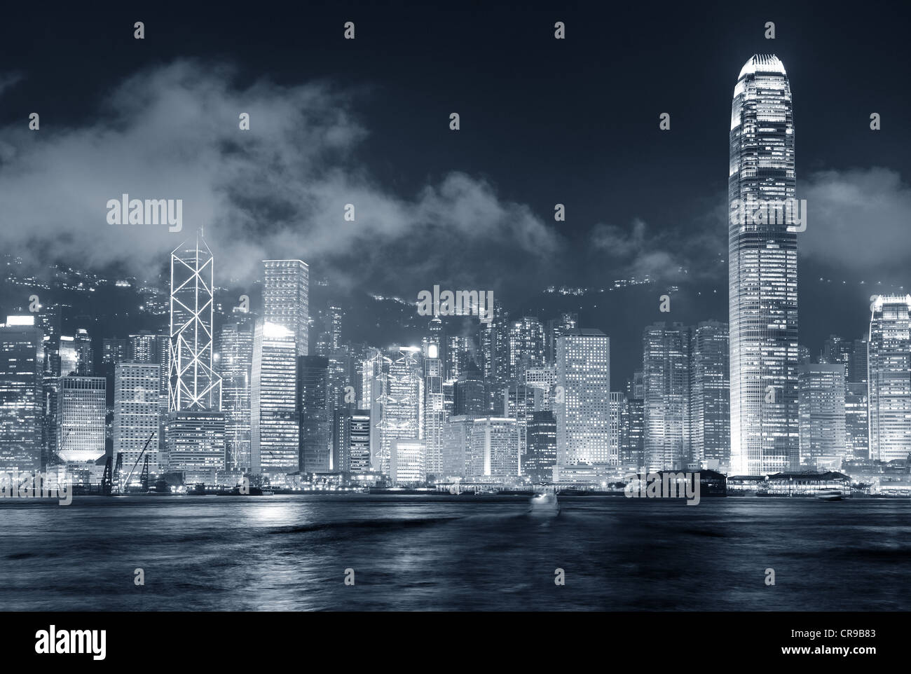 Hong Kong skyline at night with clouds over Victoria Harbour in black ...