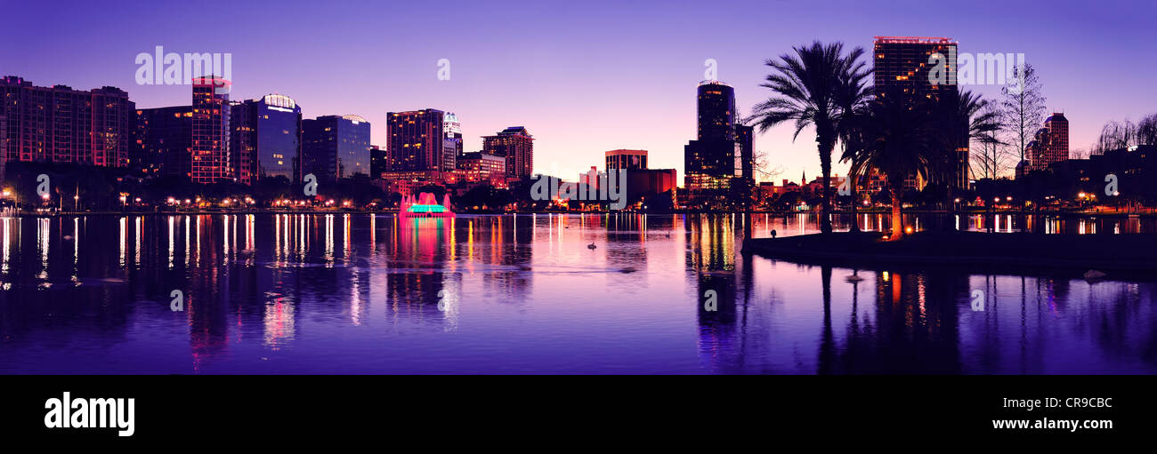 Orlando downtown skyline panorama silhouette over Lake Eola at dusk ...