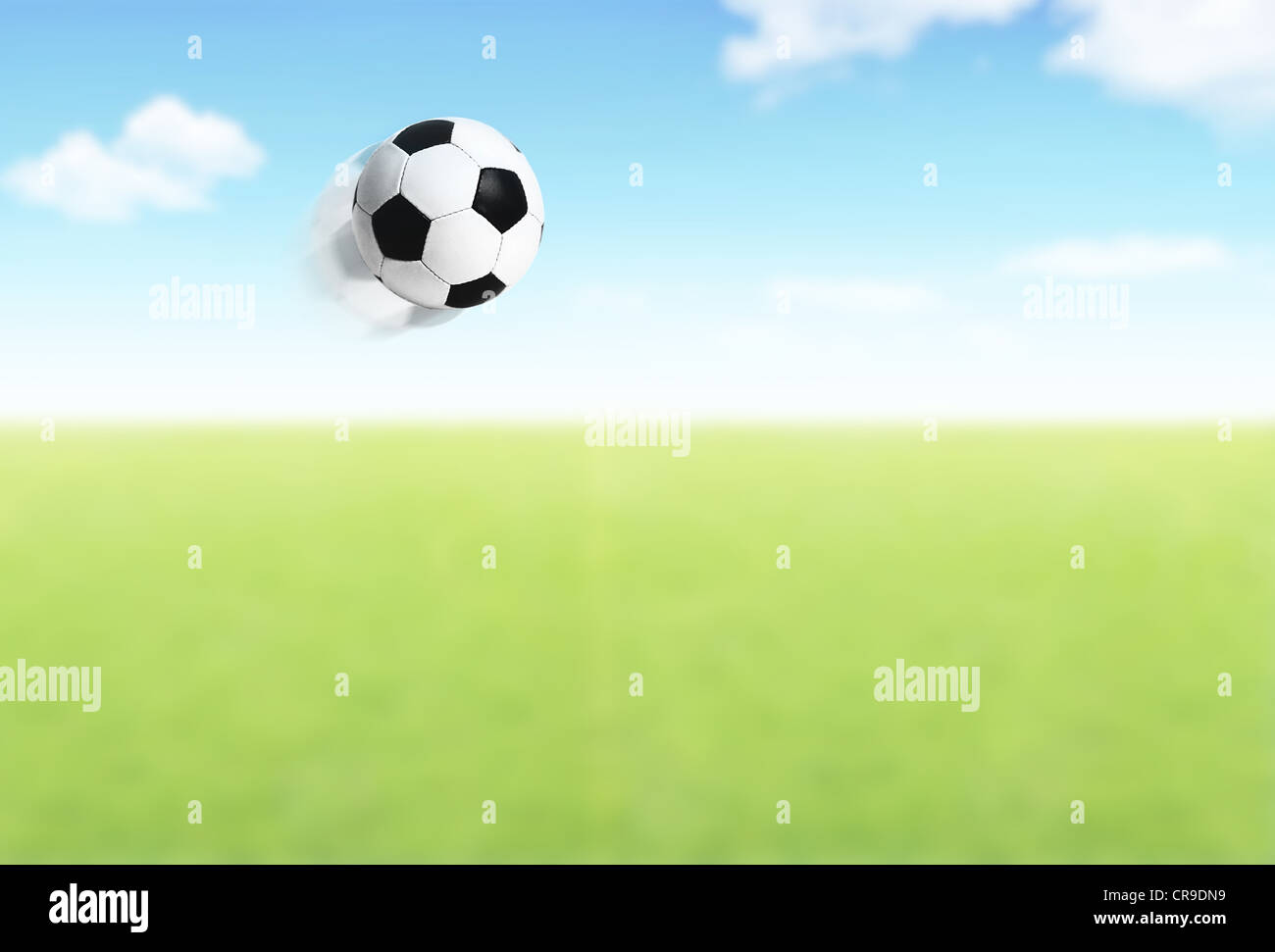 Football ball flying over field, competitive team sport, open play ...