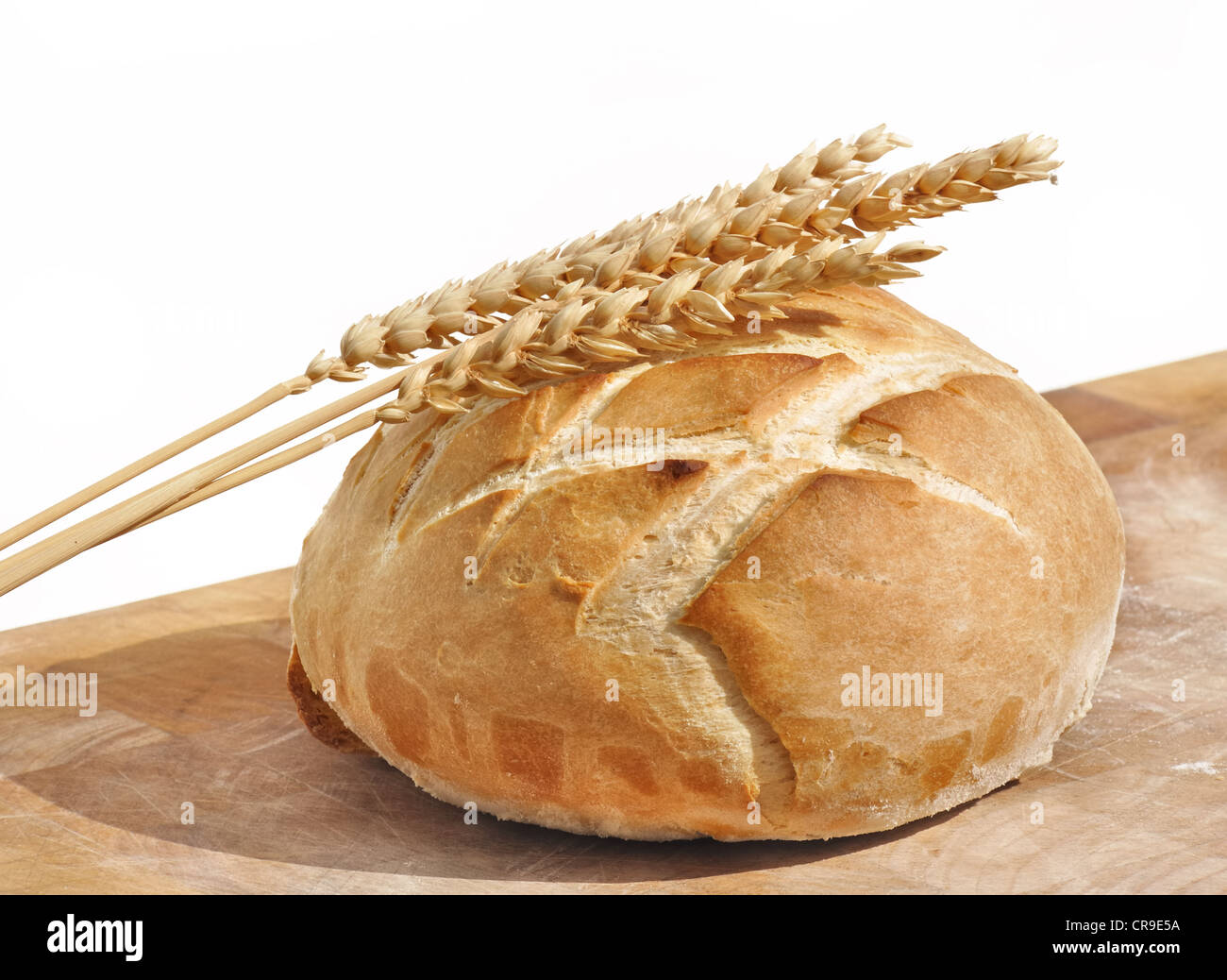 beautiful golden loaf of bread and wheat ears on white background Stock ...
