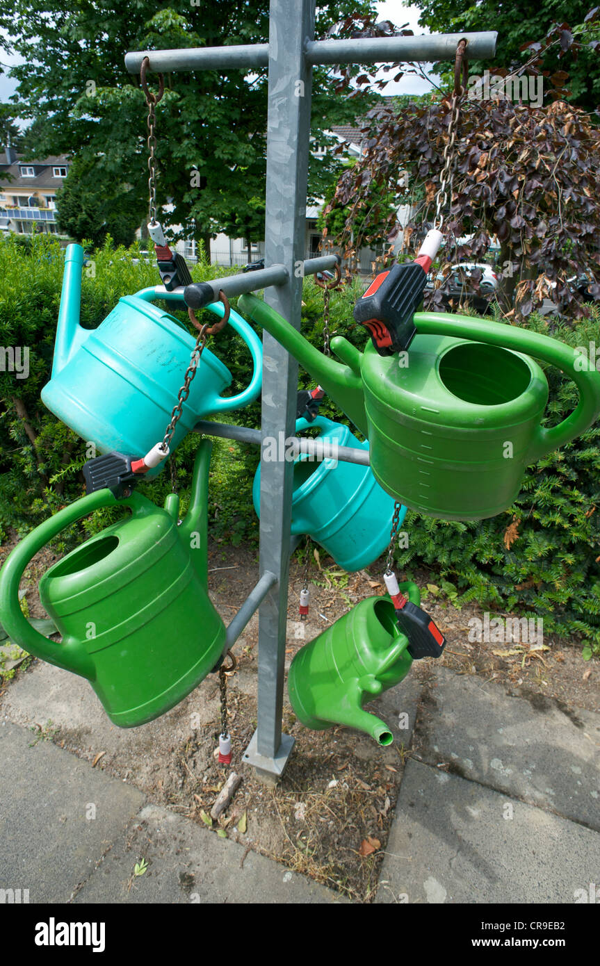 Watering can 'tree' graveyard, Germany Stock Photo - Alamy