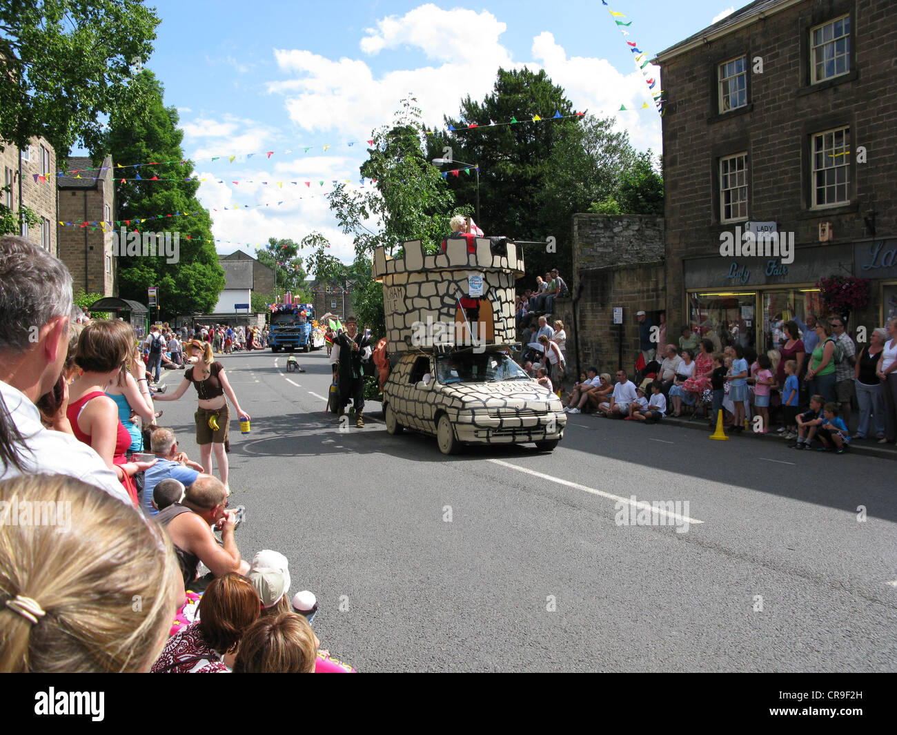 Bakewell carnival parade in Derbyshire 2009. Crowds line streets to see ...
