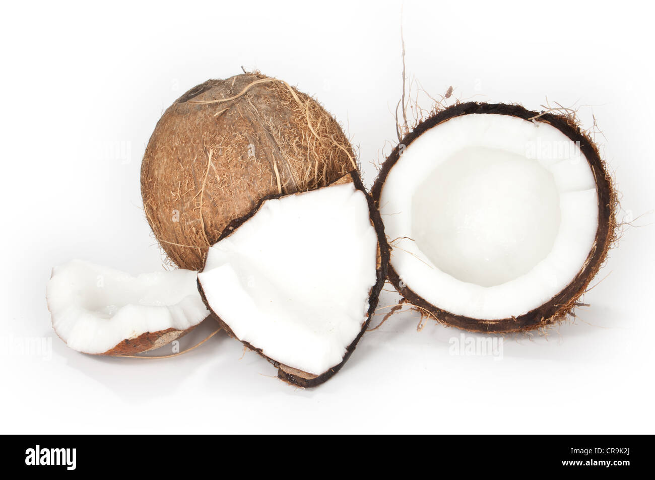 A cracked coconut on white background Stock Photo - Alamy