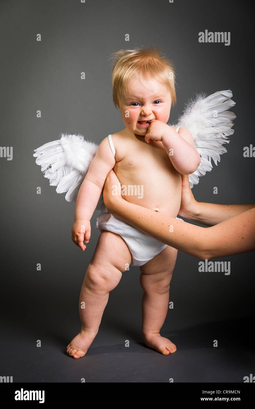 Infant angel on gray background Stock Photo - Alamy