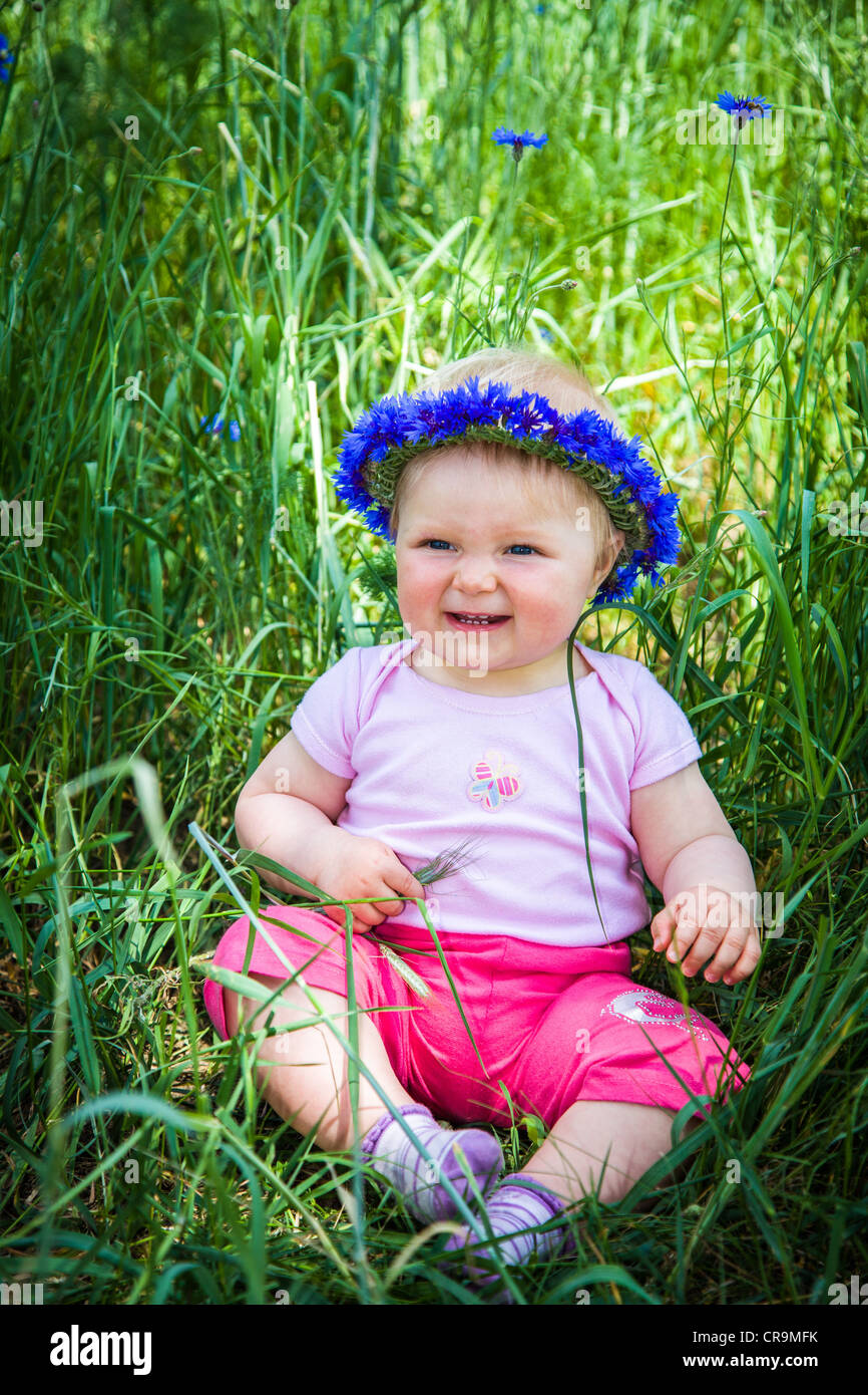Infant child on green grass Stock Photo - Alamy
