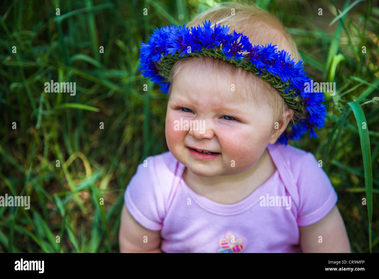 Infant child on green grass Stock Photo - Alamy
