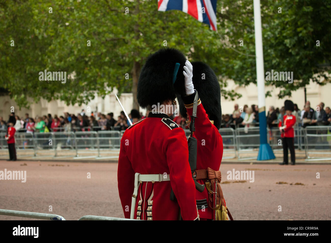 Officer straightening the hat of a foot guard in the Mall during the ...