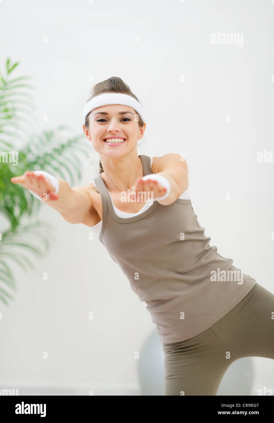 Smiling healthy woman making gymnastics exercise Stock Photo - Alamy
