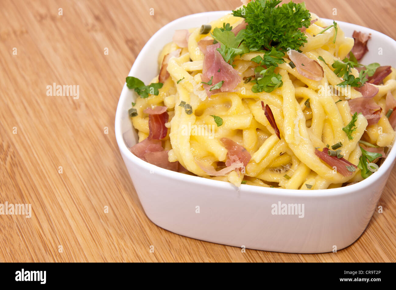 Portion of fresh Cheese Spaetzle decorated with fresh herbs Stock Photo ...