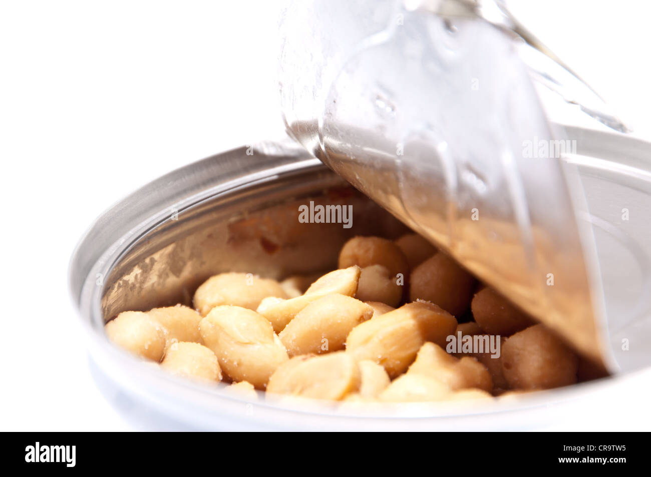 Peanuts in a can with heap in front isolated on white background Stock ...