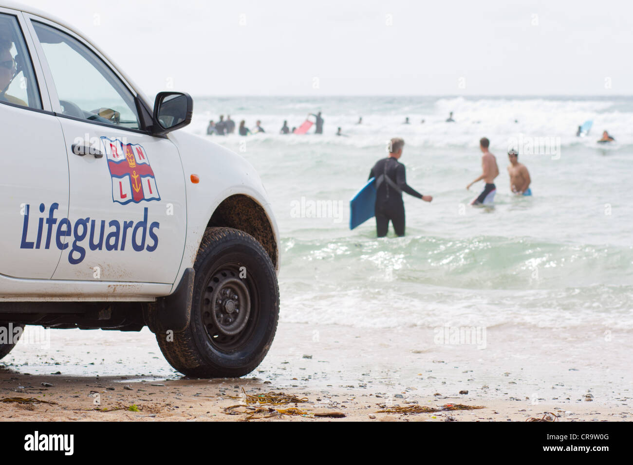 A lifeguard sitting in his van whilst watching the beach to keep it ...