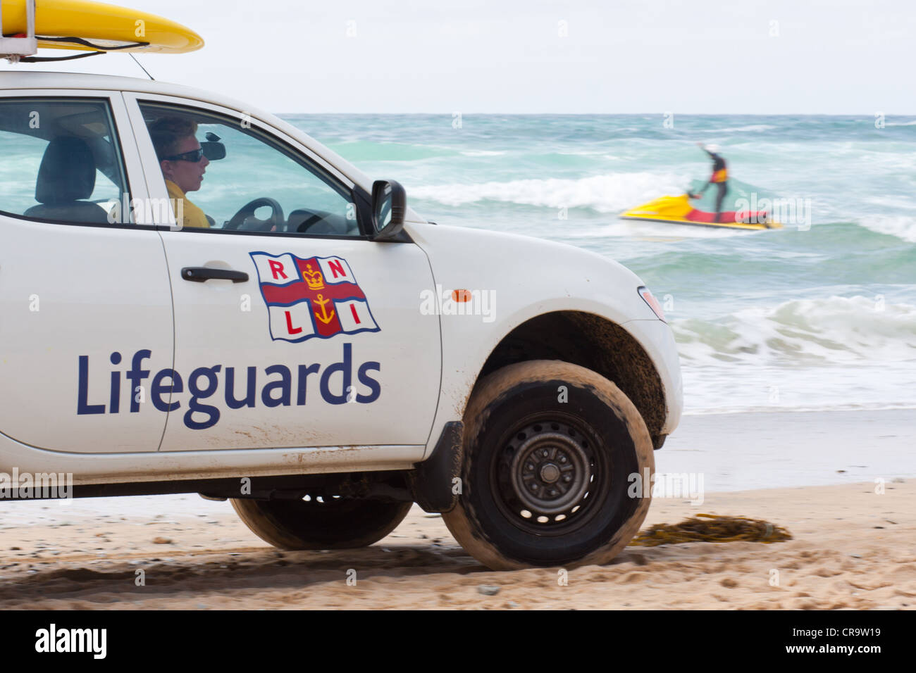 A lifeguard sitting in his van whilst watching the beach to keep it ...