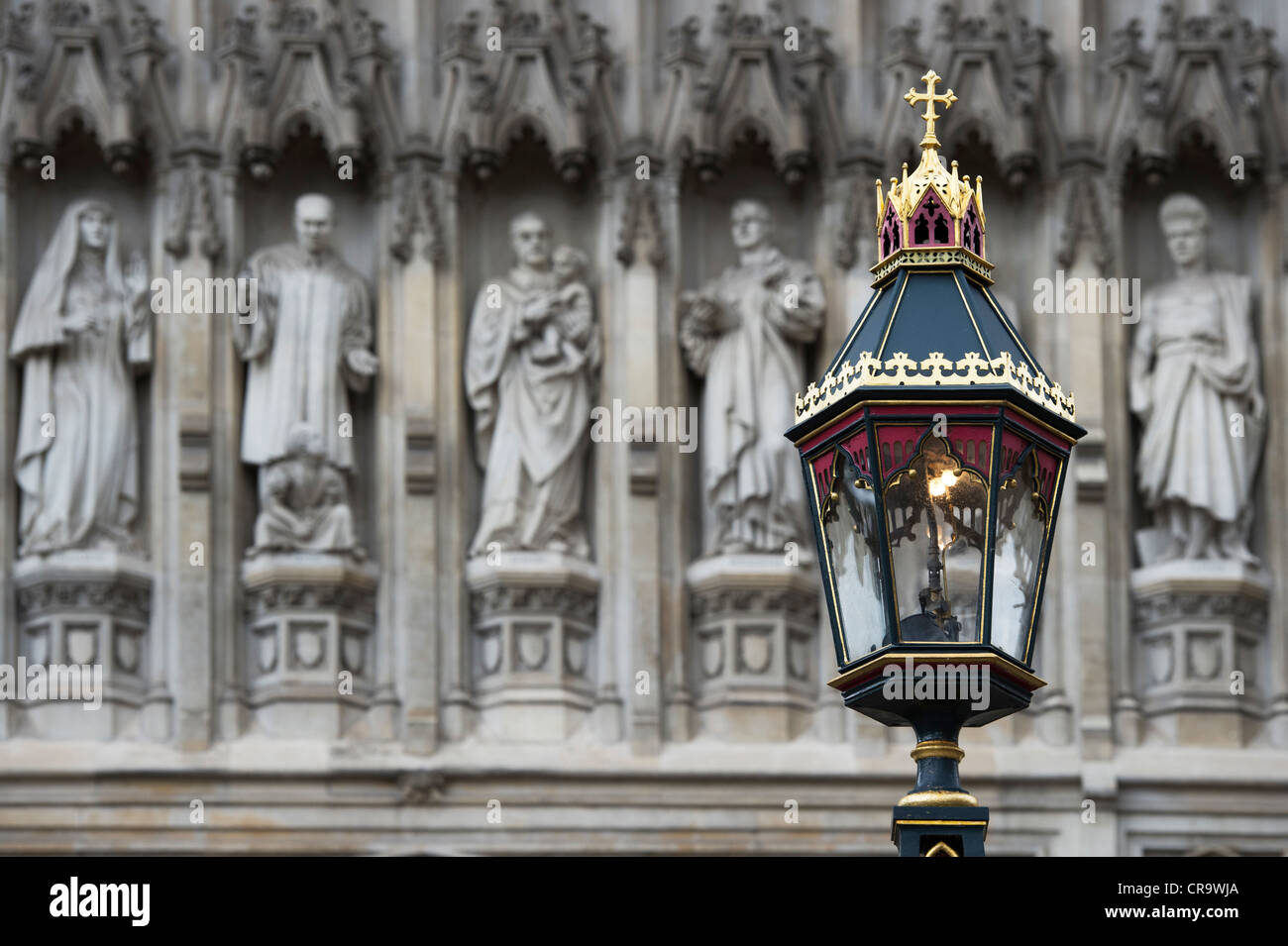 Lamp in front of stone sculptures at Westminster Abbey. London. England ...