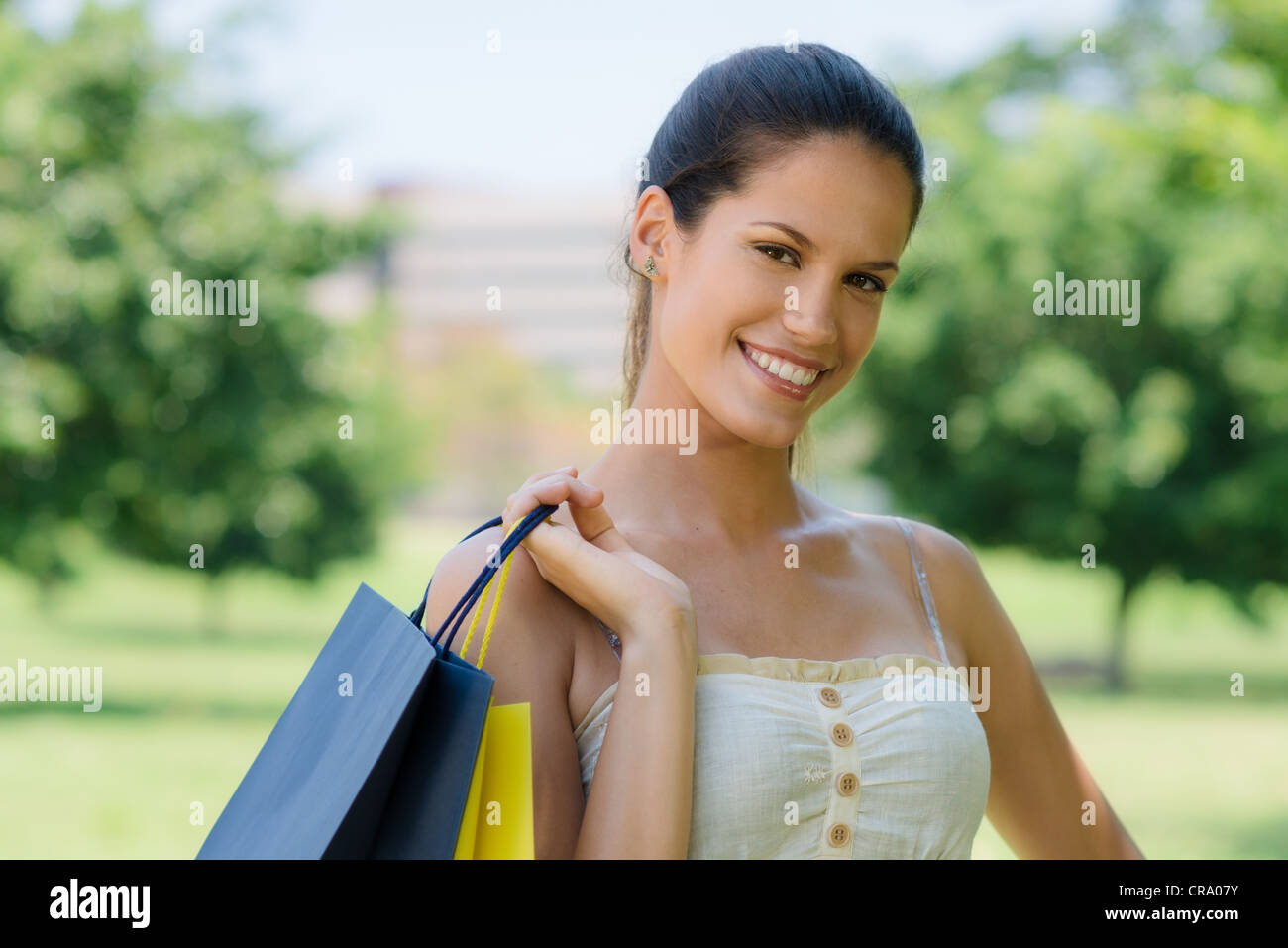 Consumerism, portrait of happy young woman smiling with shopping bags ...