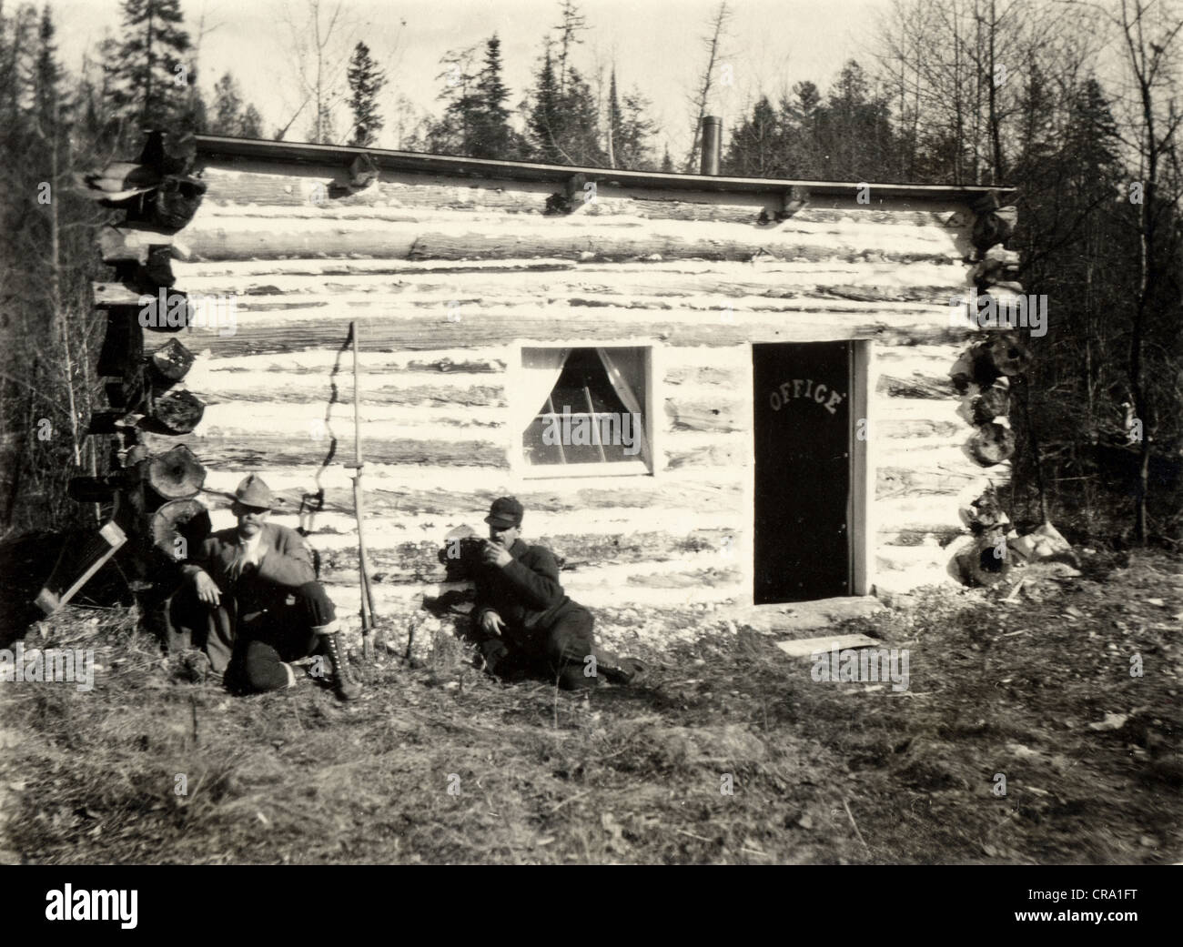 Two Men at Crude Log Cabin Office Stock Photo - Alamy