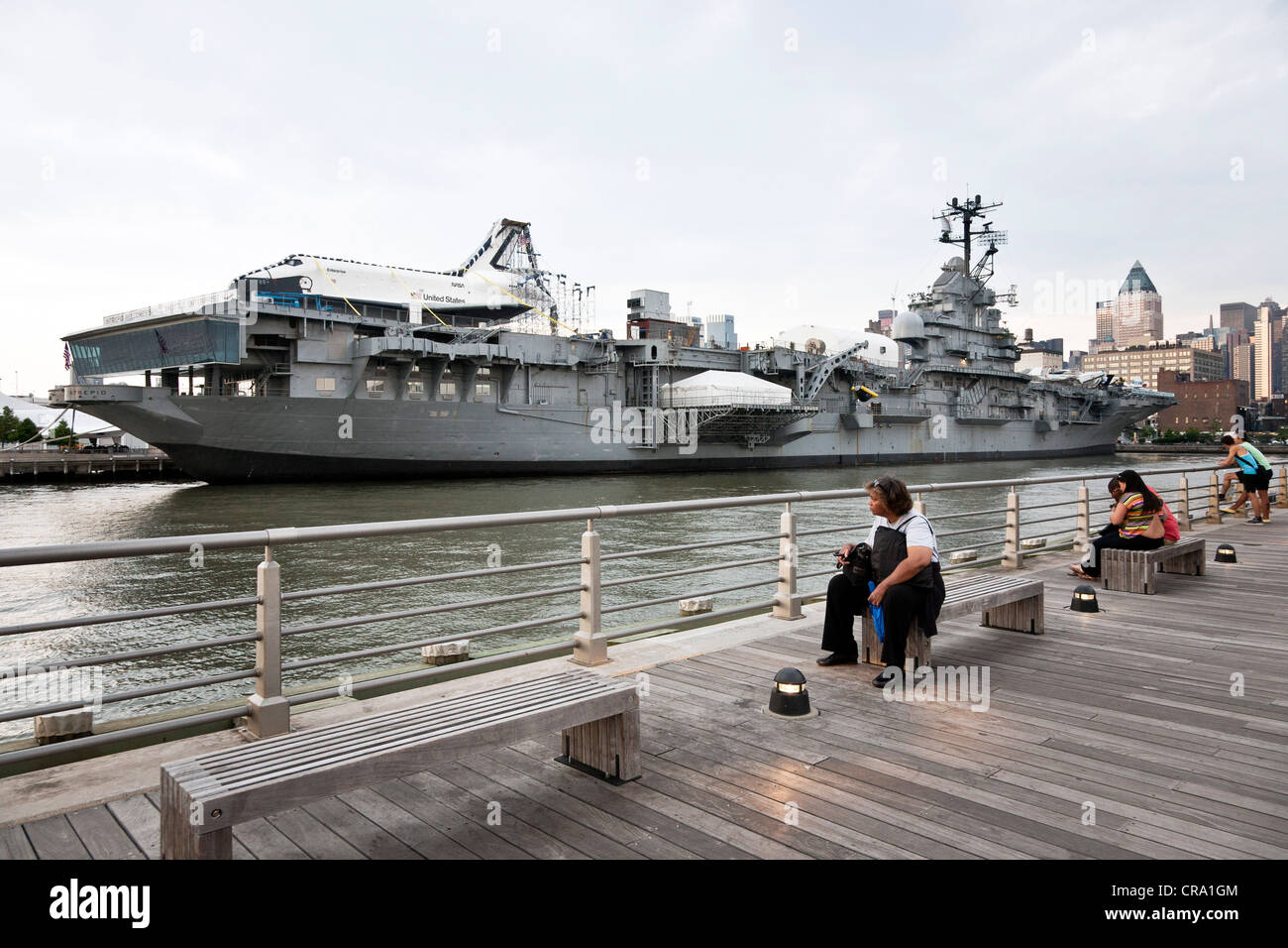 people on Hudson River Pier 84 view space shuttle Enterprise being ...