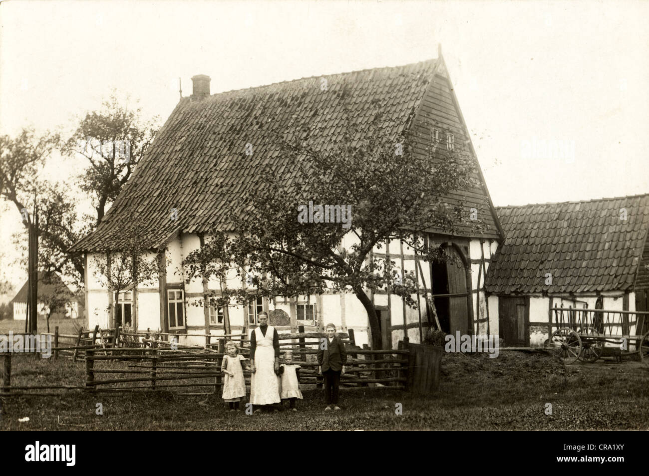 Mother & Three Children at Half-Timbered European Farmhouse Stock Photo ...