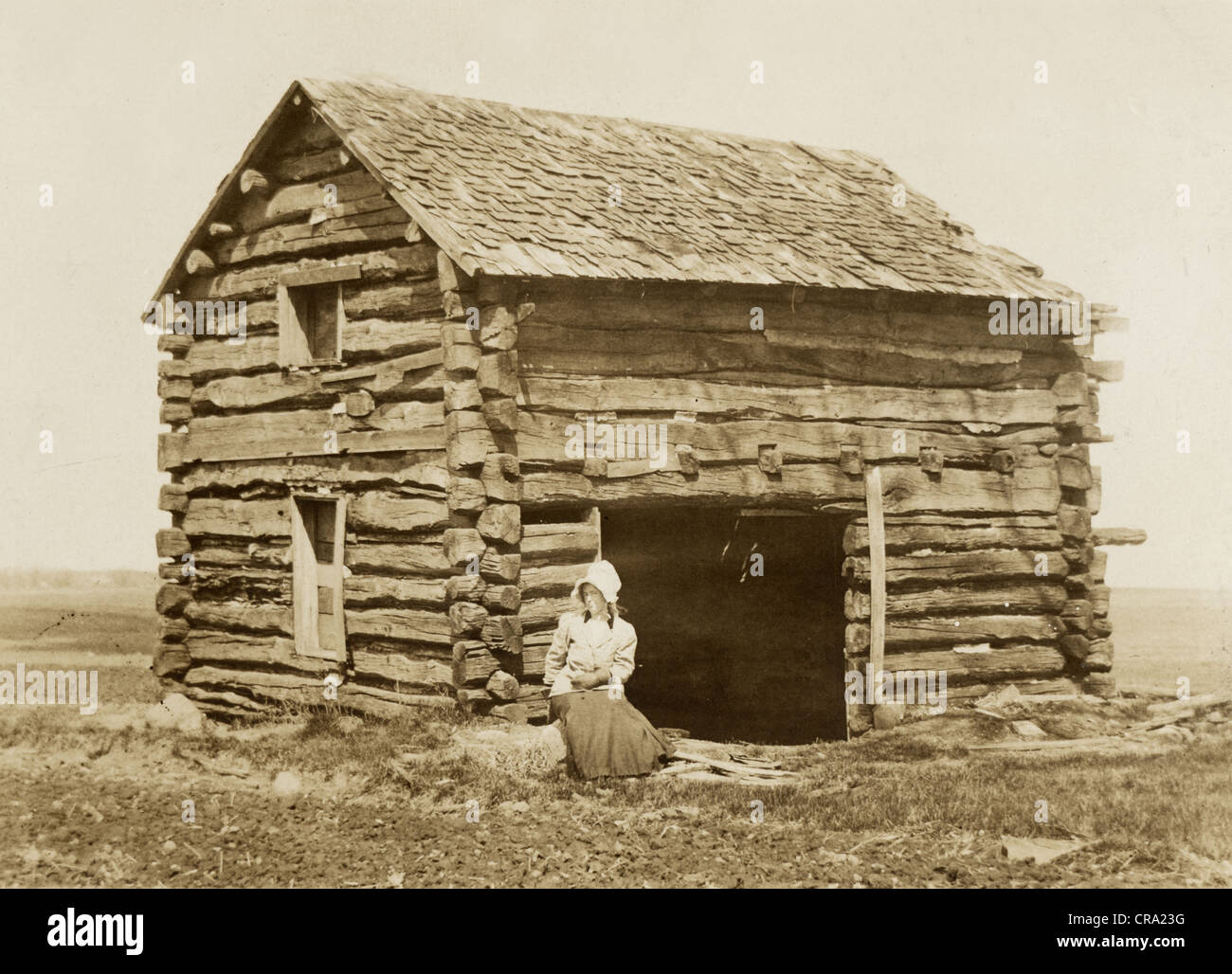 Young Woman at Crude Western Log Cabin Barn Stock Photo - Alamy