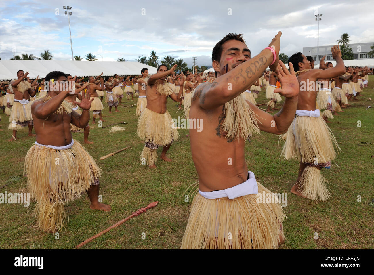 Men wearing traditional costumes dancing at the closing ceremony of ...