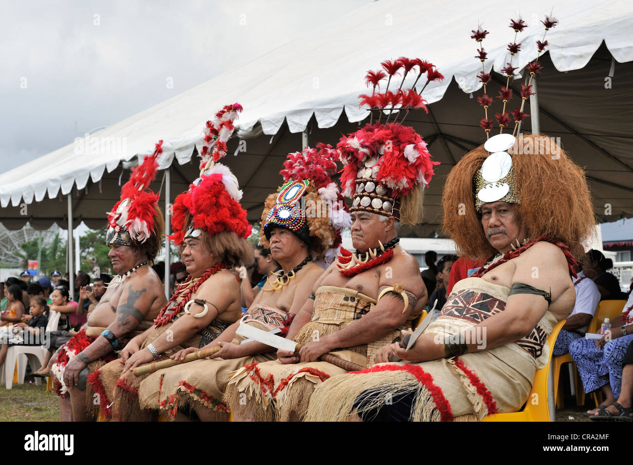 Five Matai (chiefs) with traditional headdress watch the celebrations ...