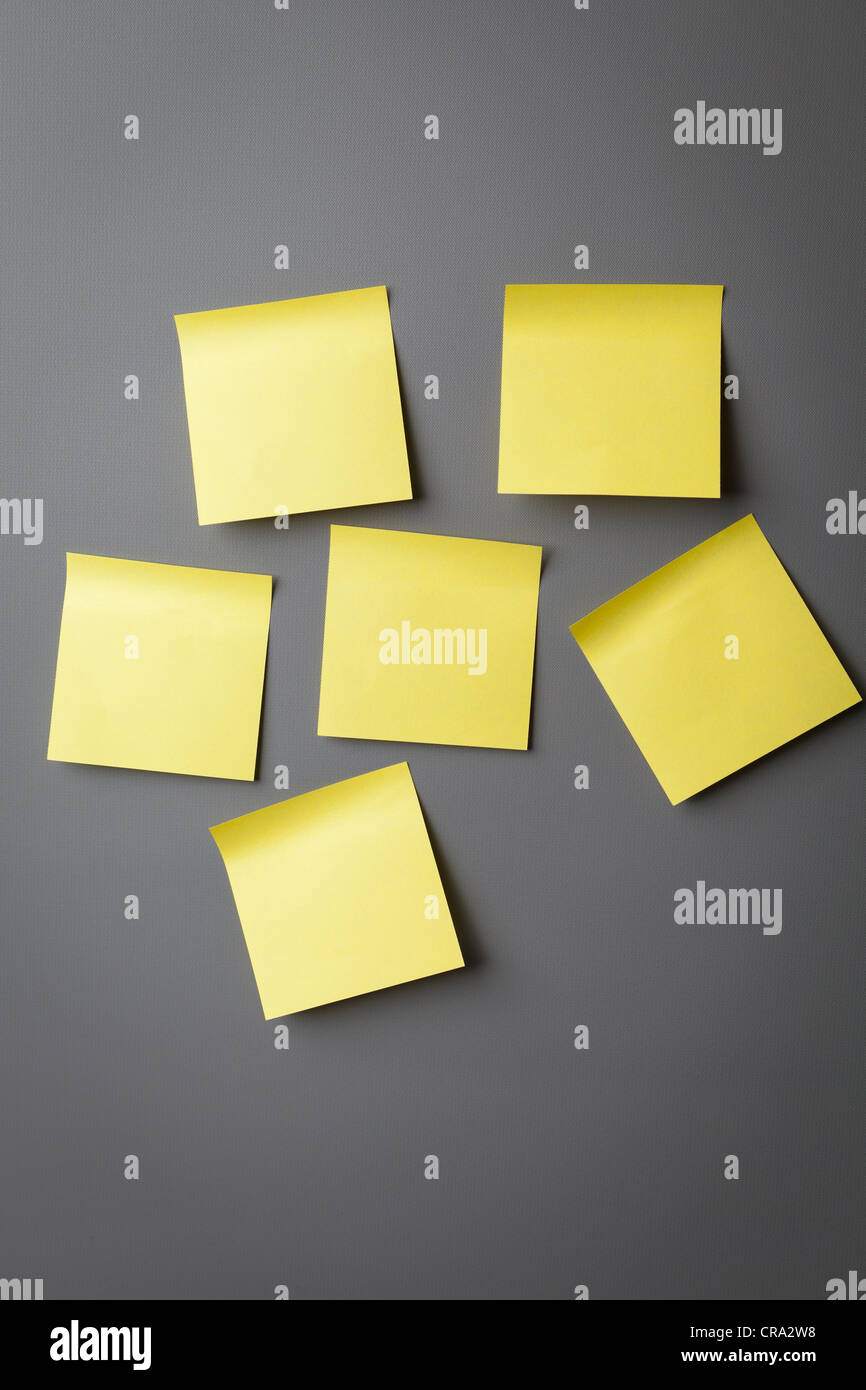 Yellow sticky notes on a grey wall Stock Photo - Alamy