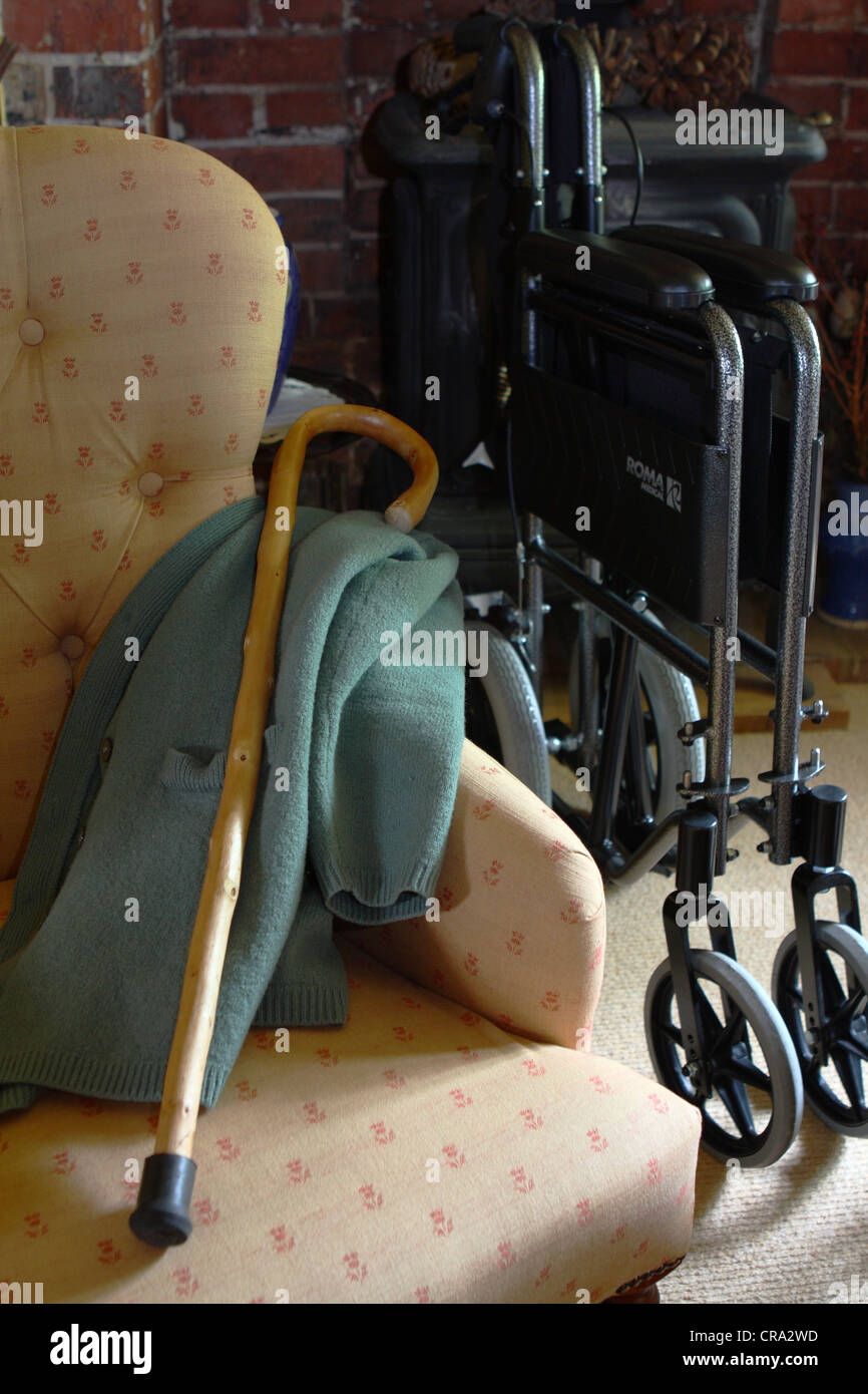 A walking stick and cardigan resting on a chair in a room with a ...