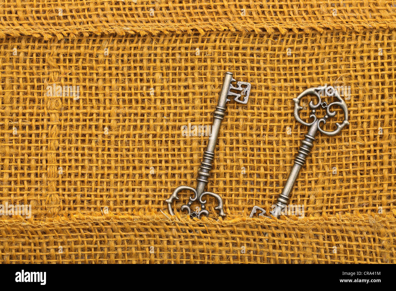 Antique key on burlap background Stock Photo - Alamy