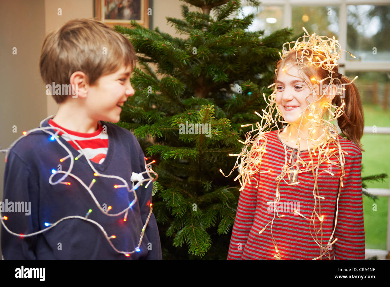 Children playing with Christmas lights Stock Photo - Alamy