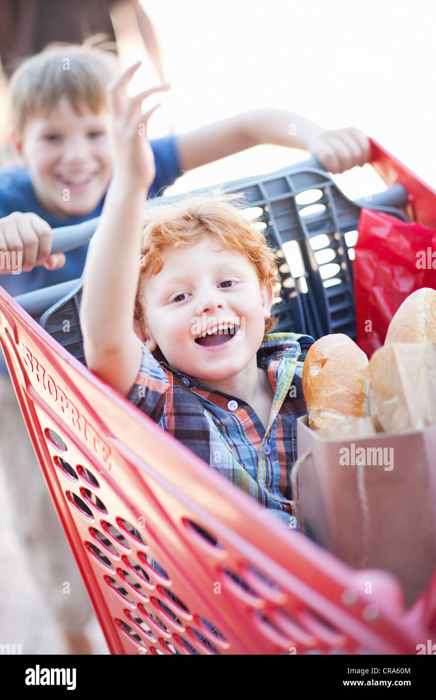 Children playing with shopping cart Stock Photo - Alamy