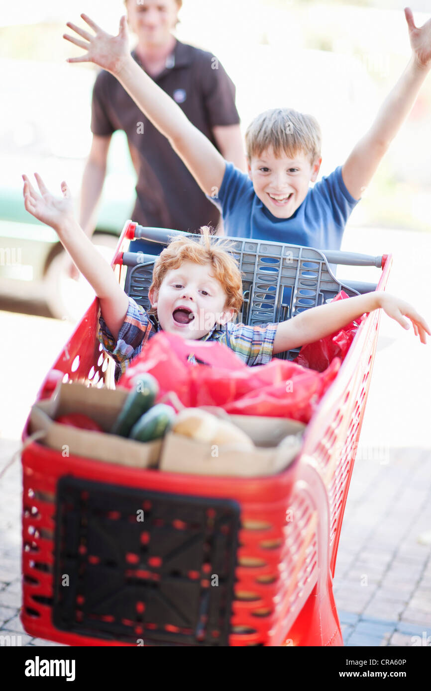 Children playing with shopping cart Stock Photo - Alamy