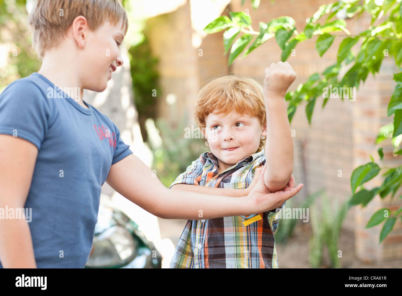 Boys showing of muscles hi-res stock photography and images - Alamy