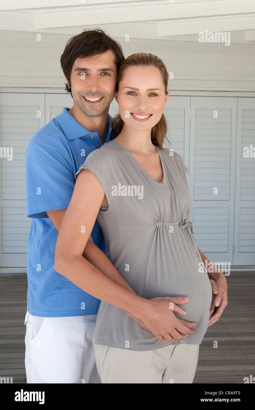 Man holding pregnant girlfriends belly Stock Photo - Alamy
