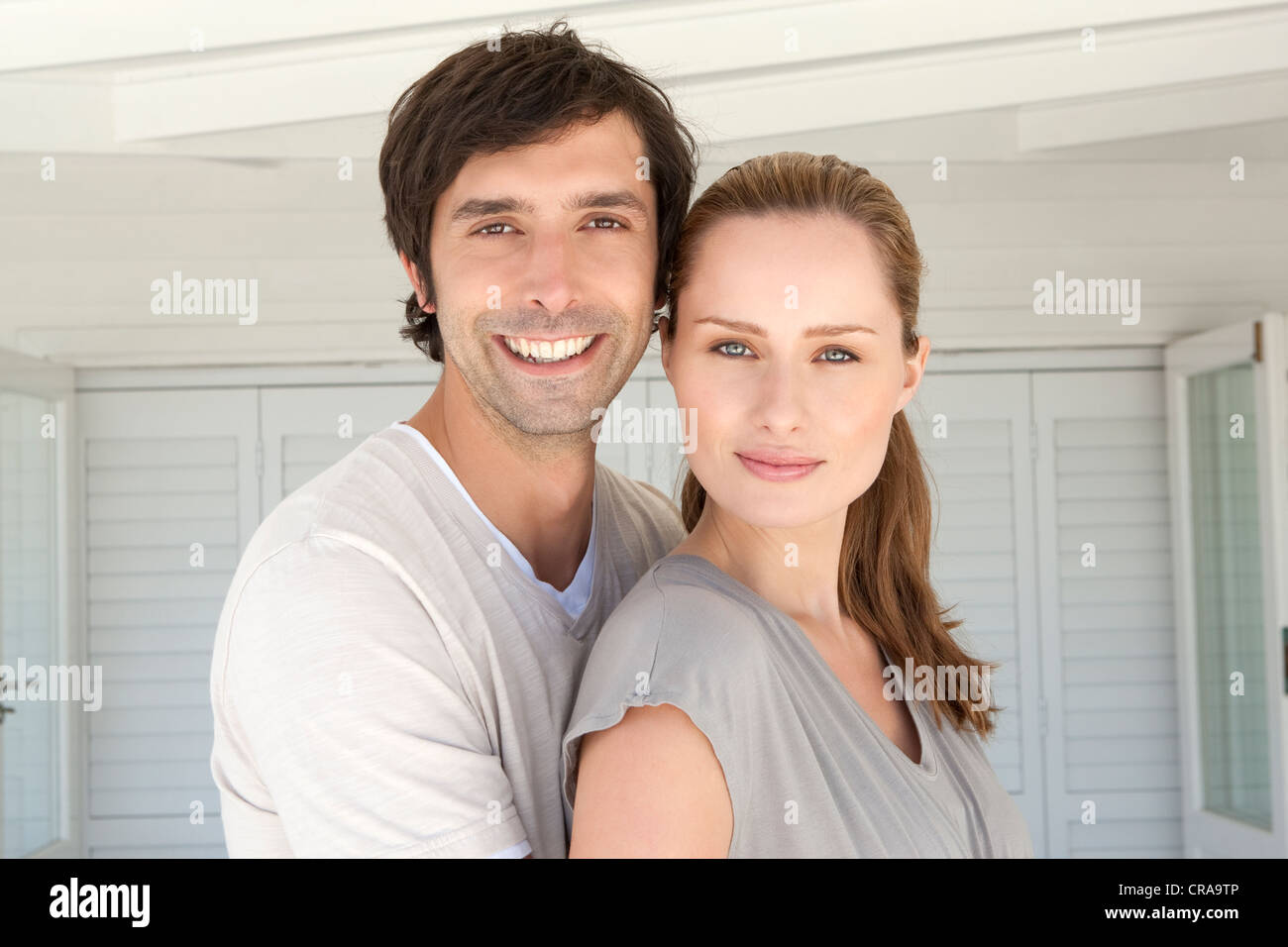 Smiling couple standing together Stock Photo - Alamy
