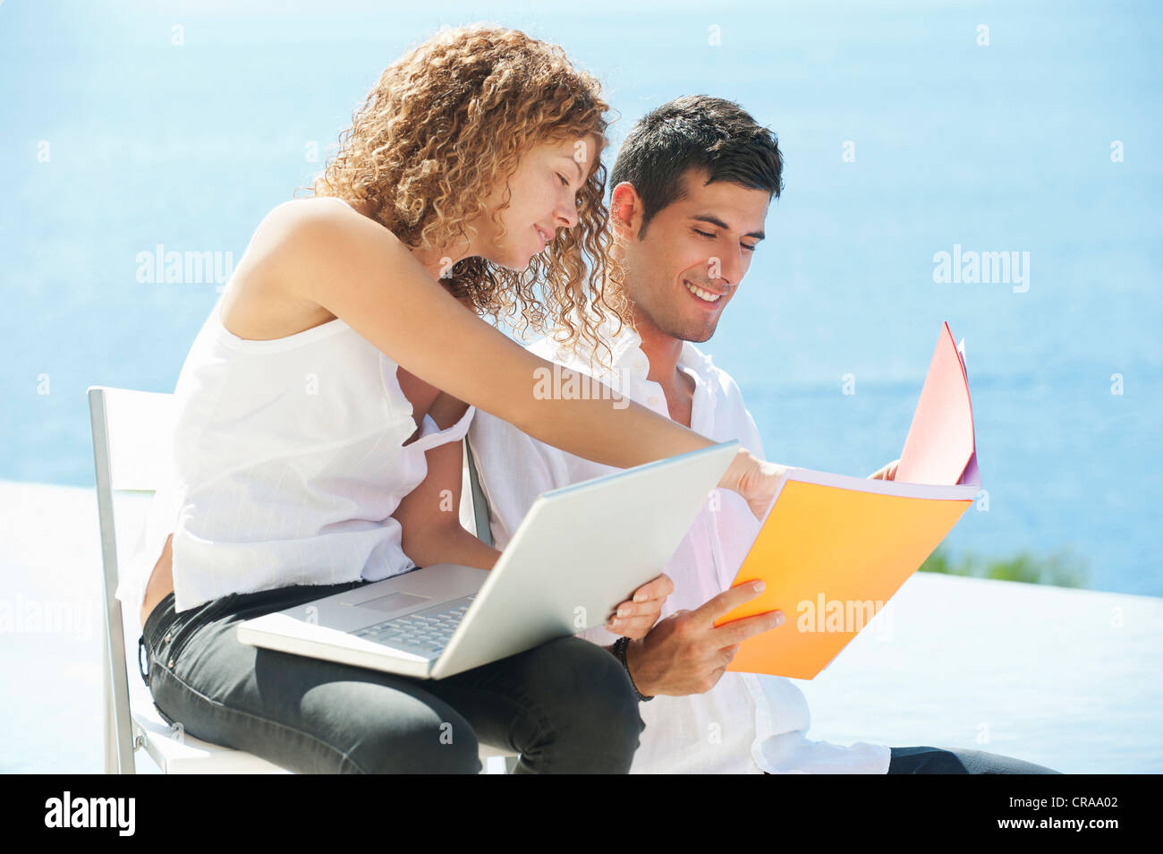 Couple working together outdoors Stock Photo - Alamy