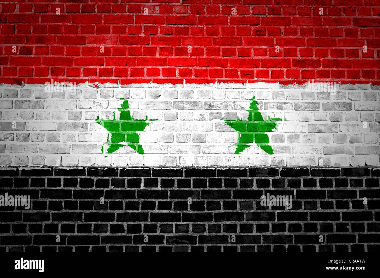 An image of the Syria flag painted on a brick wall in an urban location ...