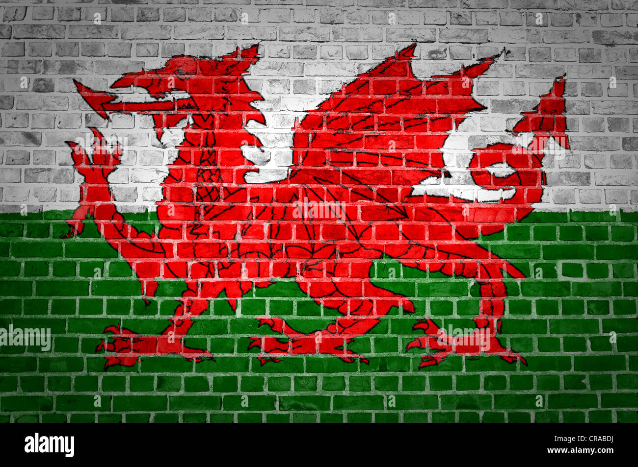 An image of the Wales flag painted on a brick wall in an urban location ...